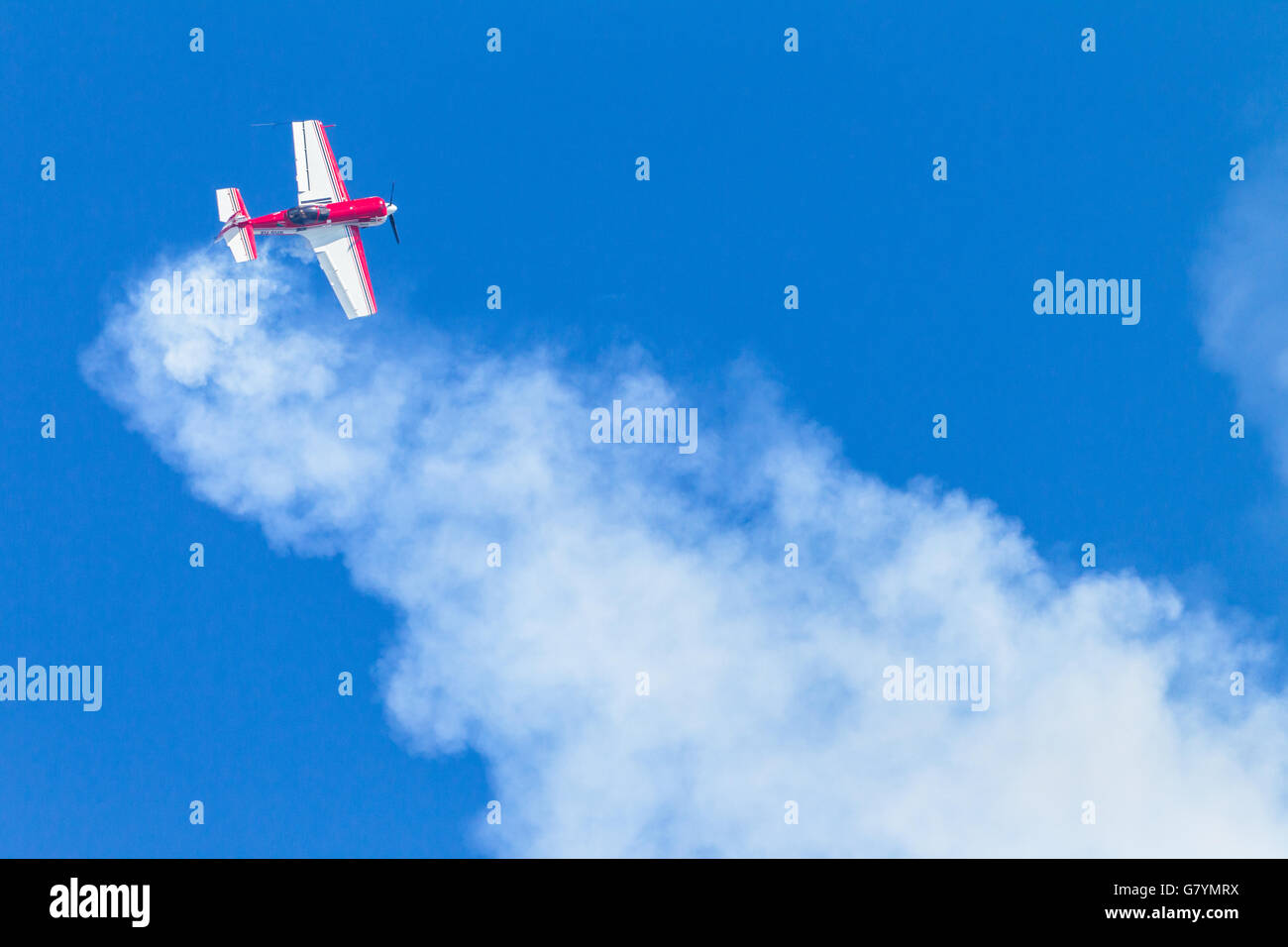Aircraft acrobatics plane pilot flying action in blue sky closeup ...