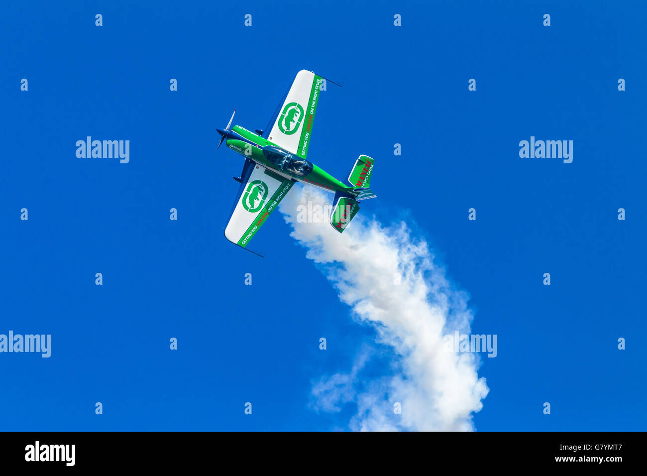 Aircraft acrobatics plane pilot flying action in blue sky closeup ...