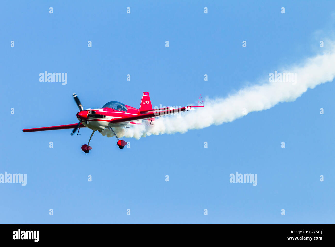 Aircraft acrobatics plane pilot flying action in blue sky closeup ...