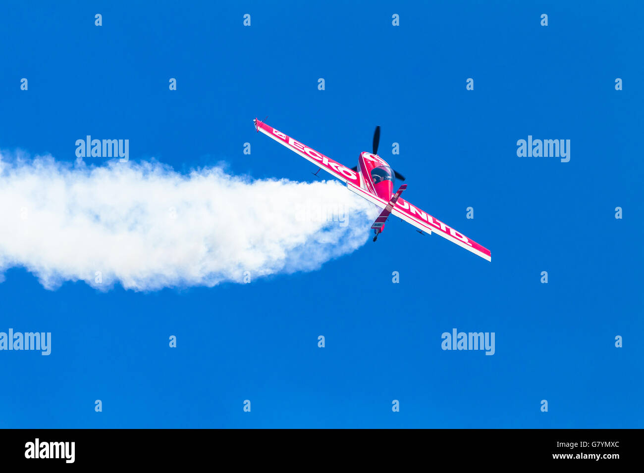 Aircraft acrobatics plane pilot flying action in blue sky closeup ...