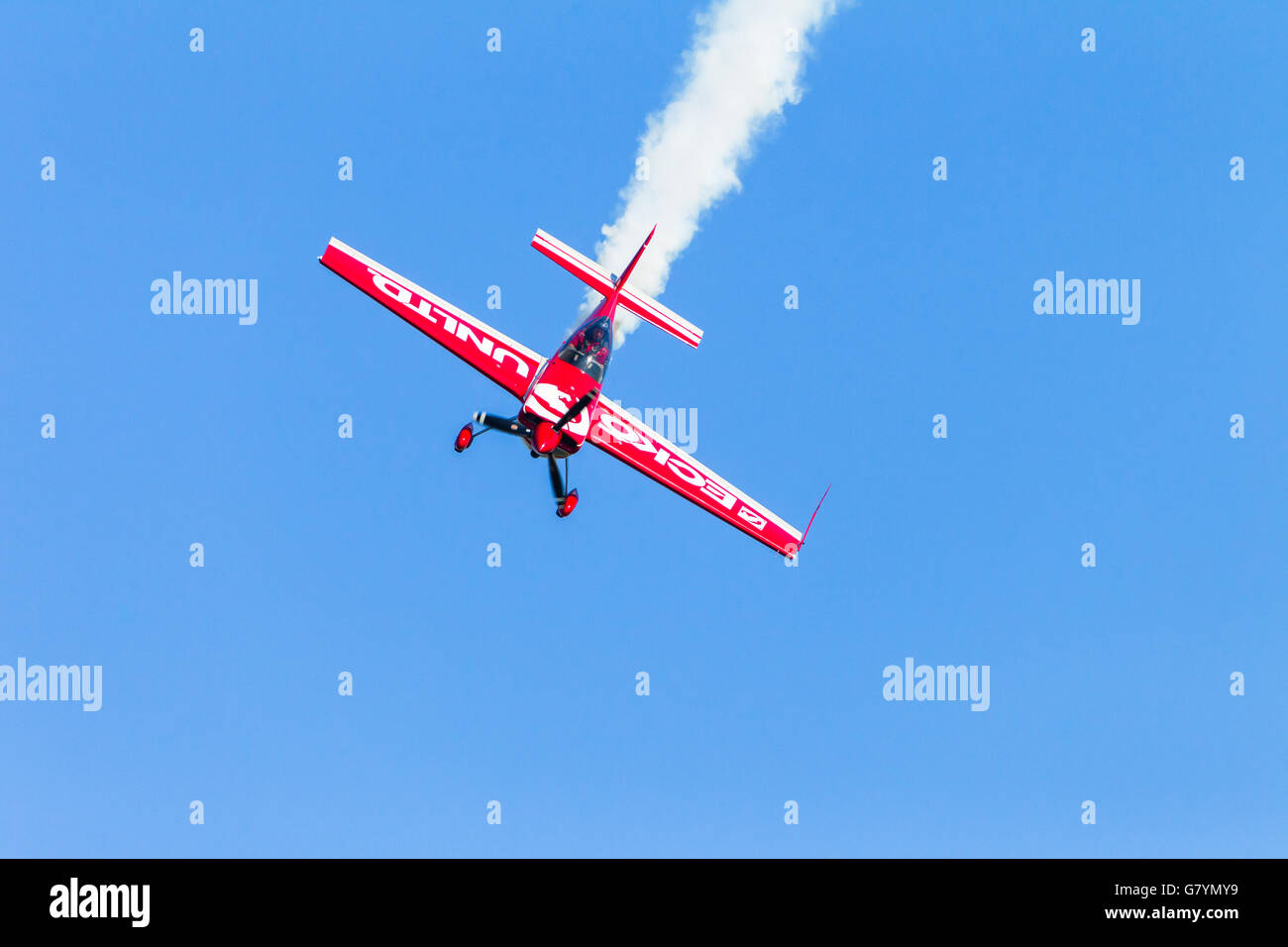 Aircraft acrobatics plane pilot flying action in blue sky closeup ...