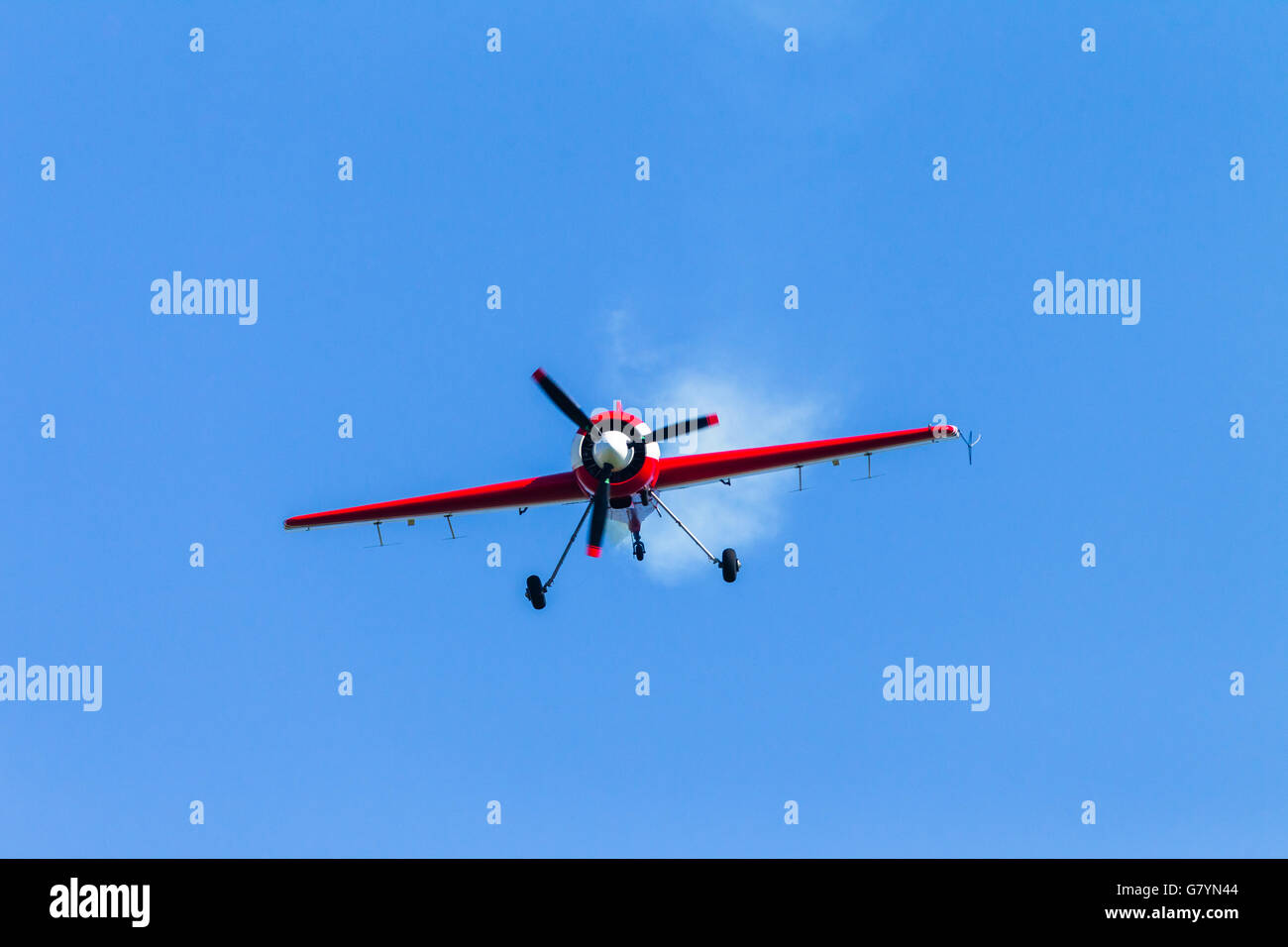 Aircraft acrobatics plane pilot flying action in blue sky closeup ...