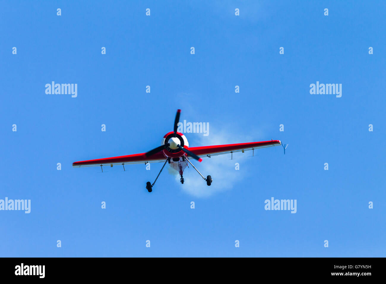 Aircraft acrobatics plane pilot flying action in blue sky closeup ...