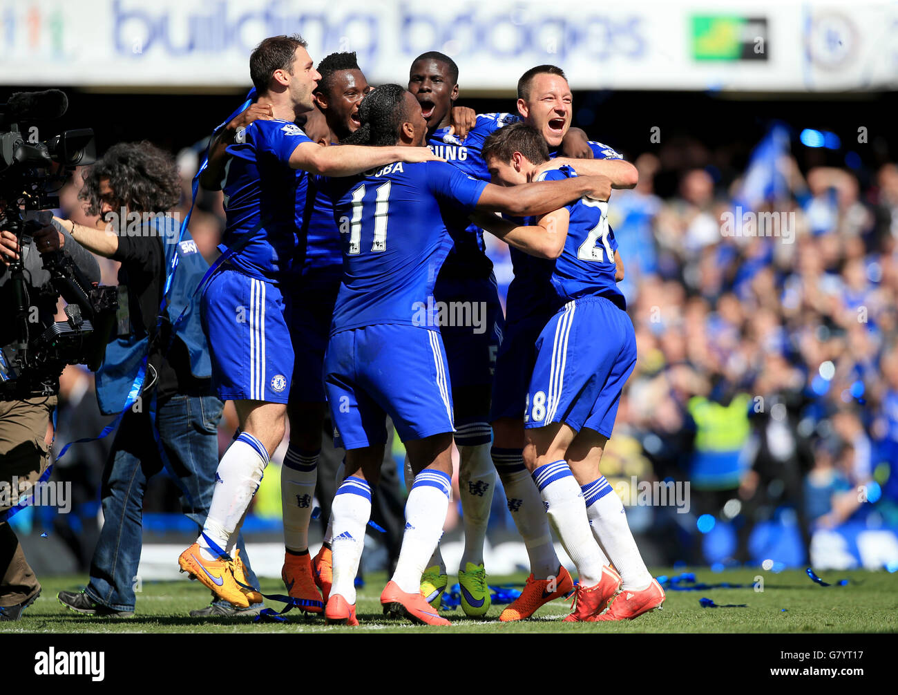 Chelsea players celebrate winning the title in a huddle after the ...