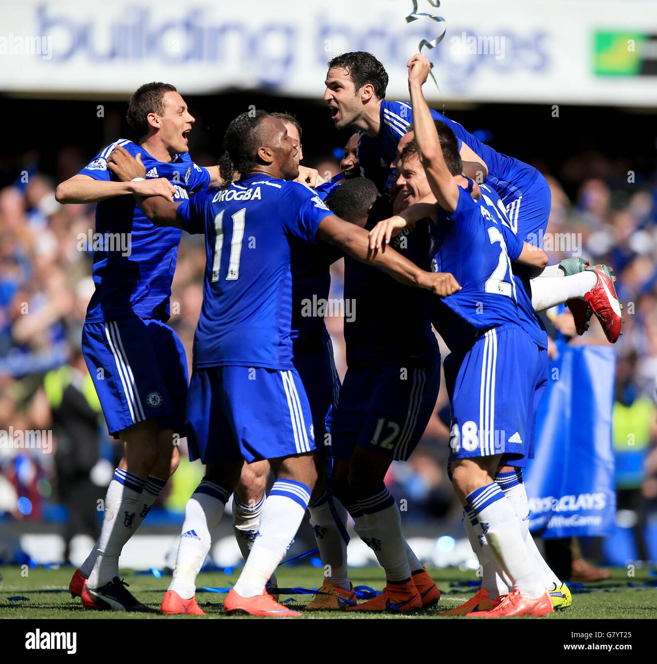 Chelsea players celebrate winning the title in a huddle after the ...