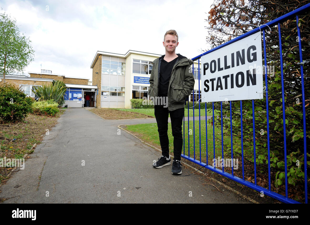 Andrew Fry, 18, stands outside a polling station in Harlow, Essex where ...