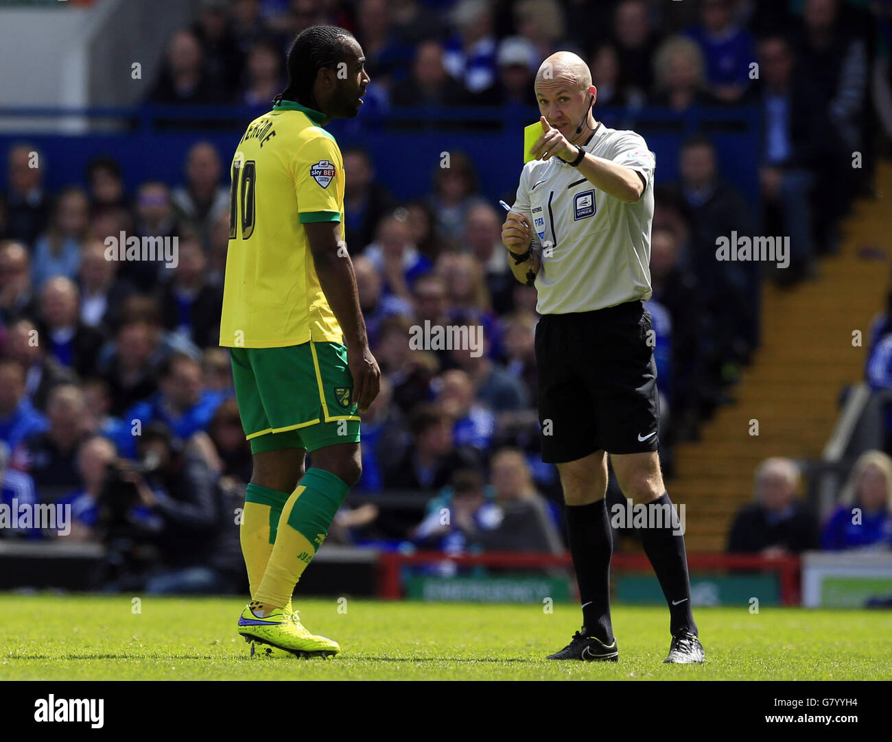 Referee Anthony Taylor (right) shows Norwich's Cameron Jerome (left ...