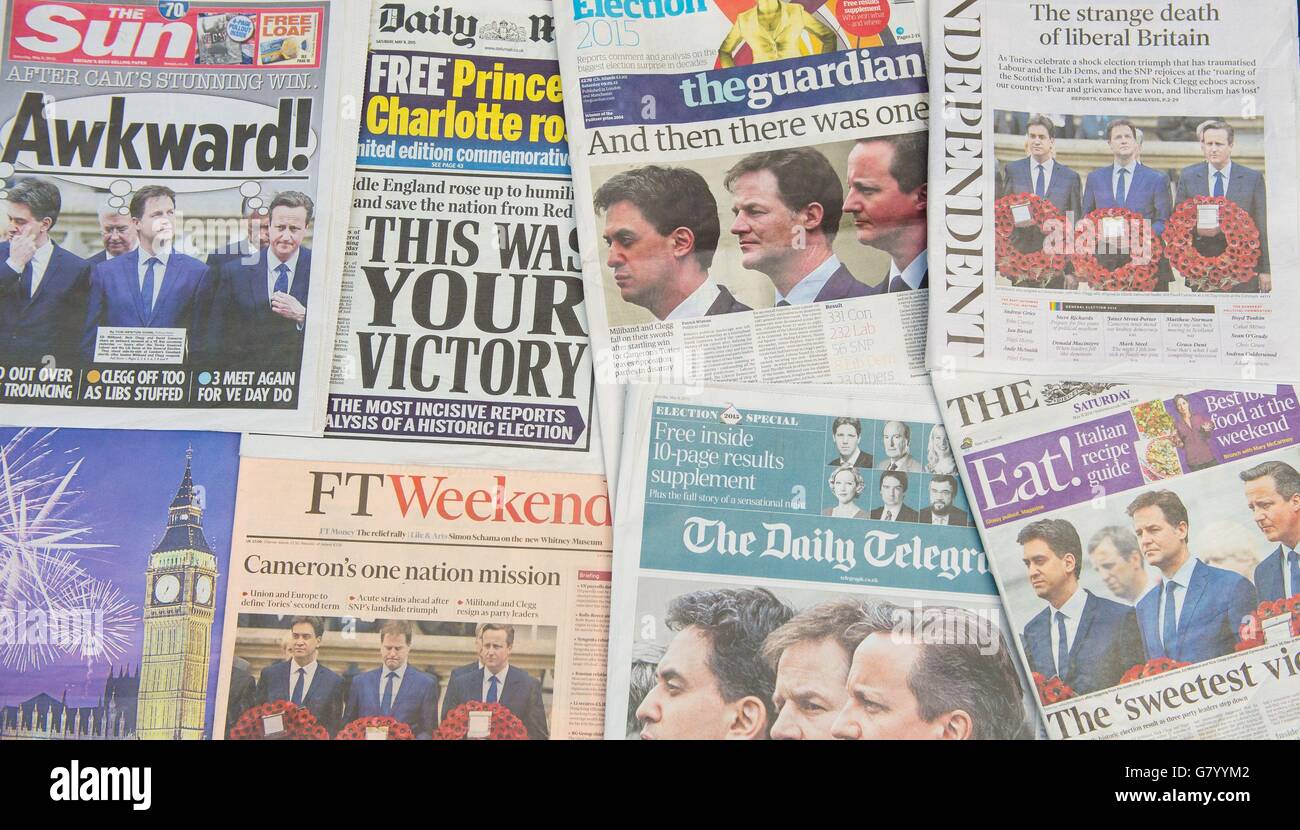 A selection of UK national newspaper front pages, on a news stand in ...