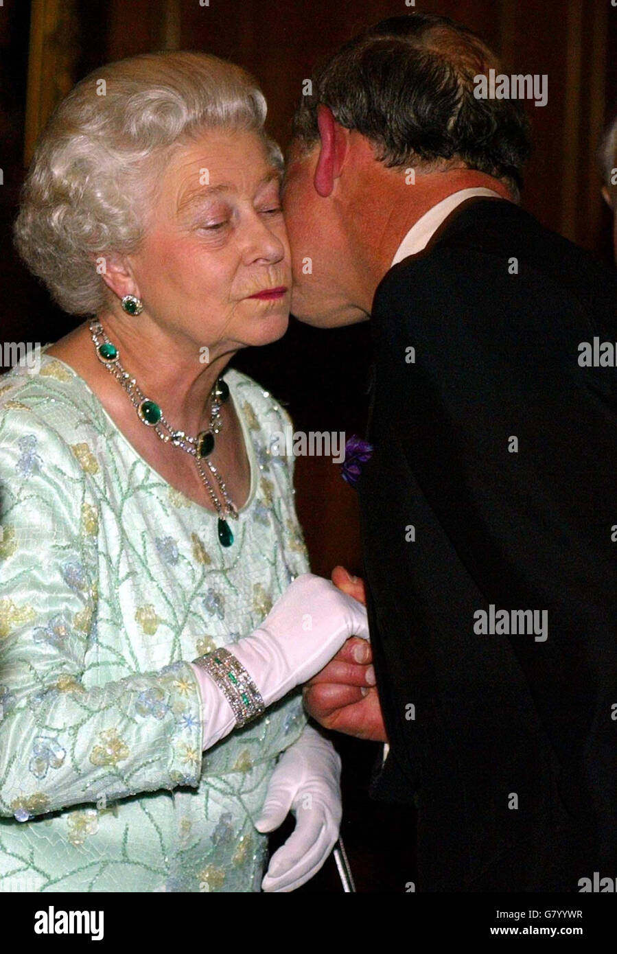 Britain's Queen Elizabeth II receives a kiss from her son the Prince of ...