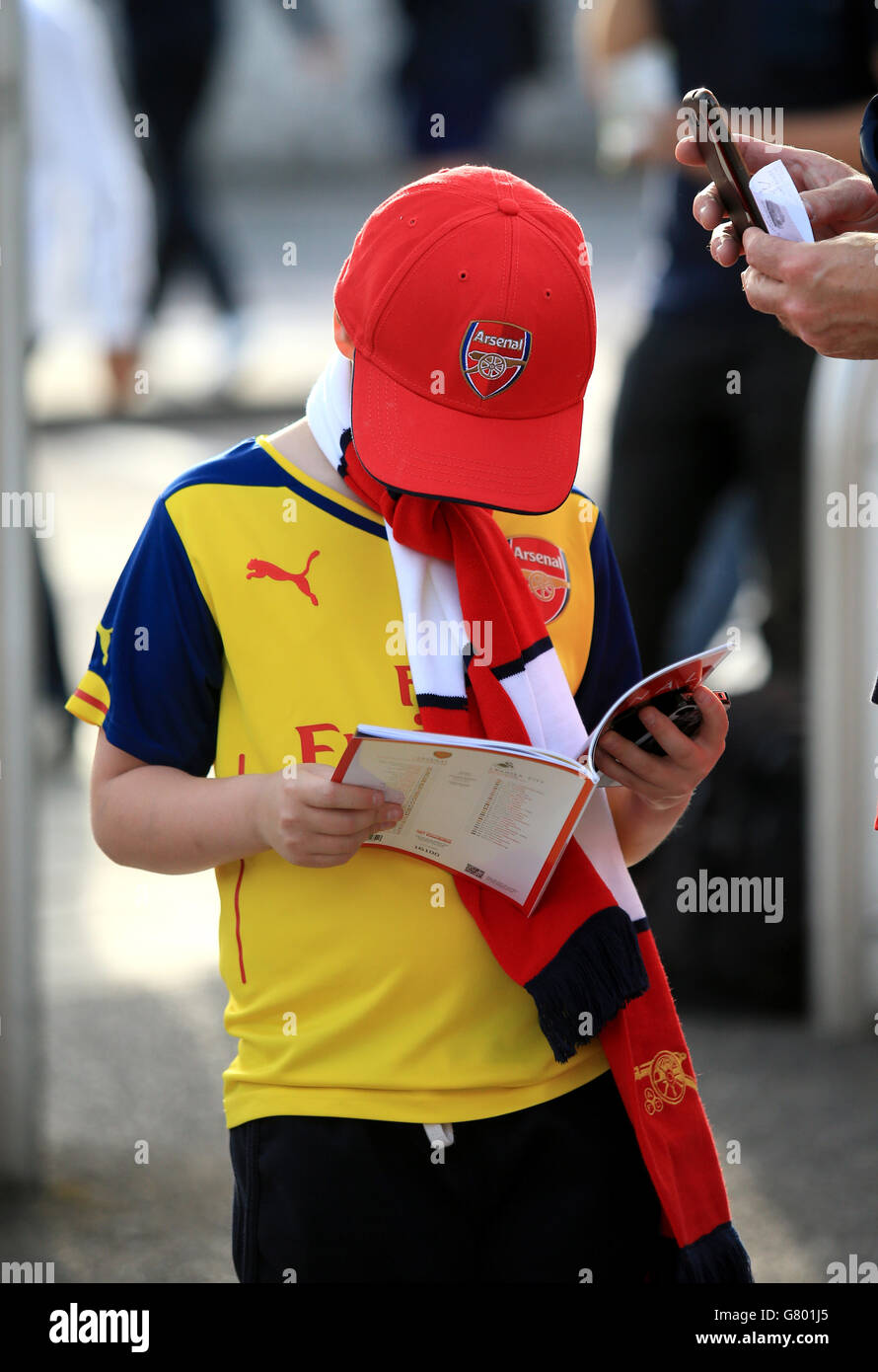 Young arsenal fan reads the matchday programme the start hi-res stock ...