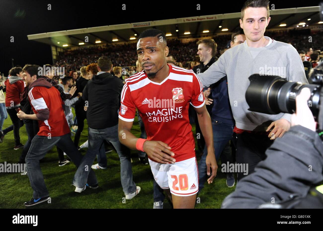 Swindon Town's Jonathan Obika is congratulated by fans as he leaves the ...