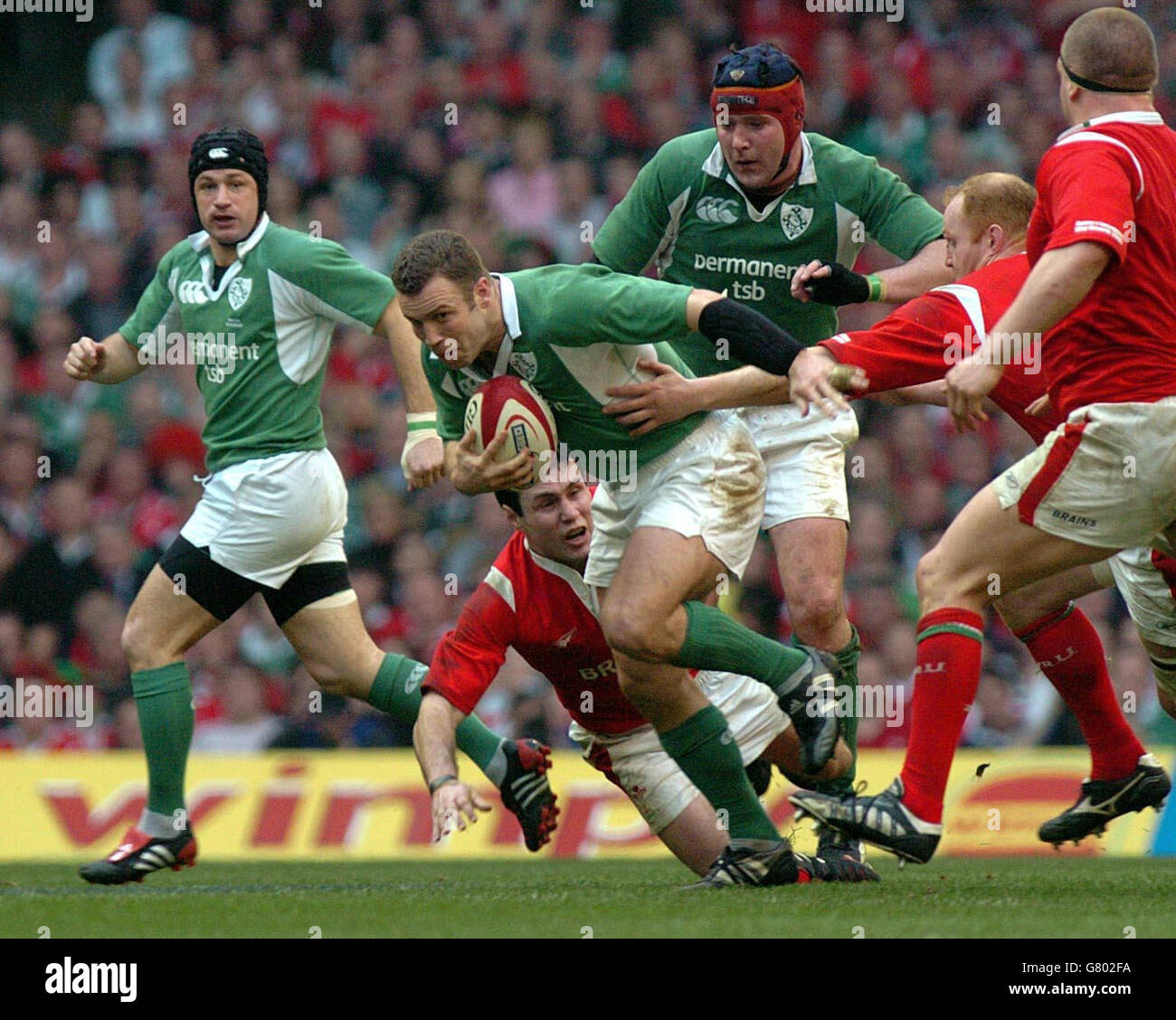 Ireland's Kevin Maggs (C) tries to break the Wales defence during his ...