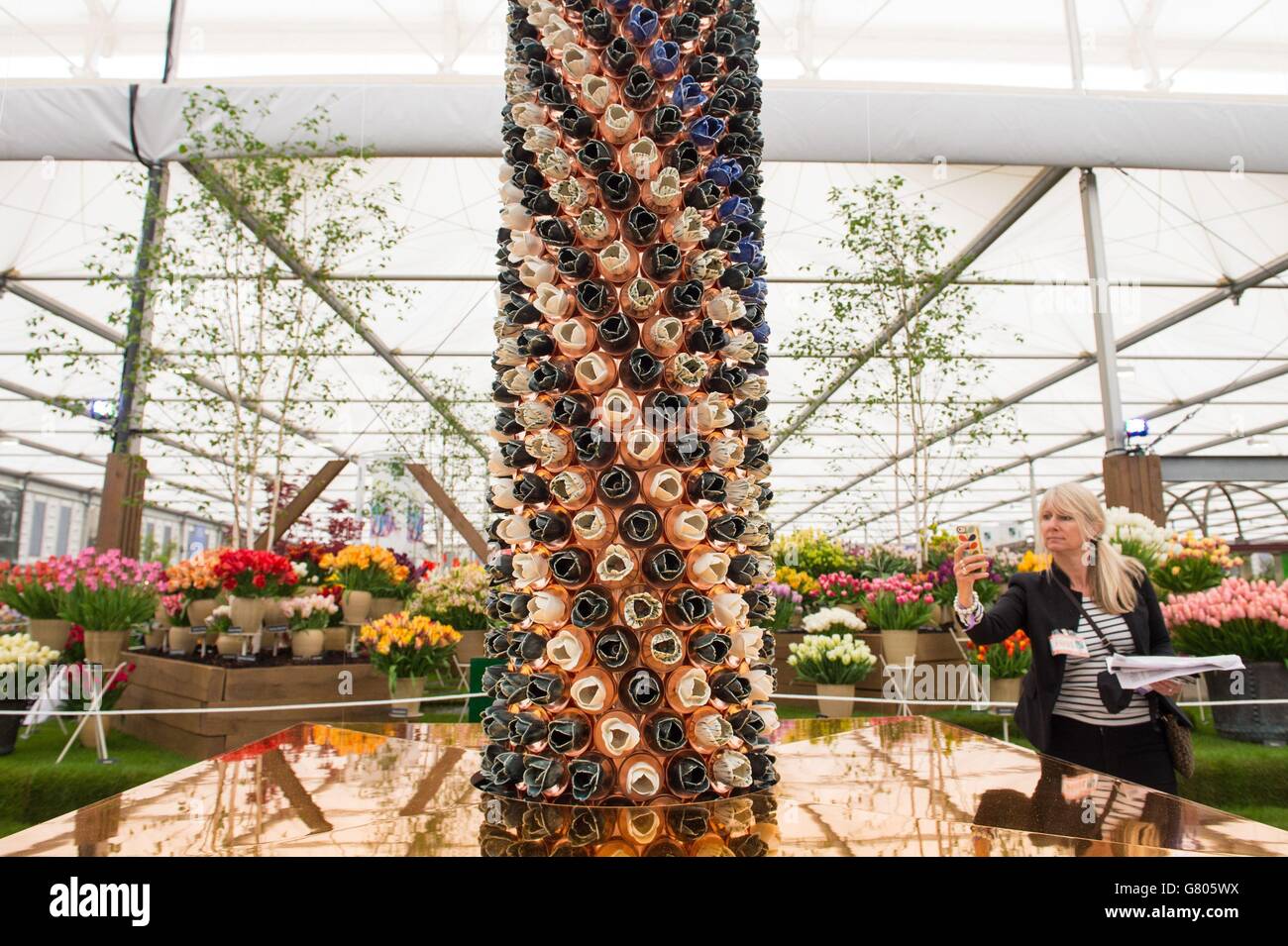 A visitor takes a photo of 'Candy', an 8 metre tower of hand-painted ...