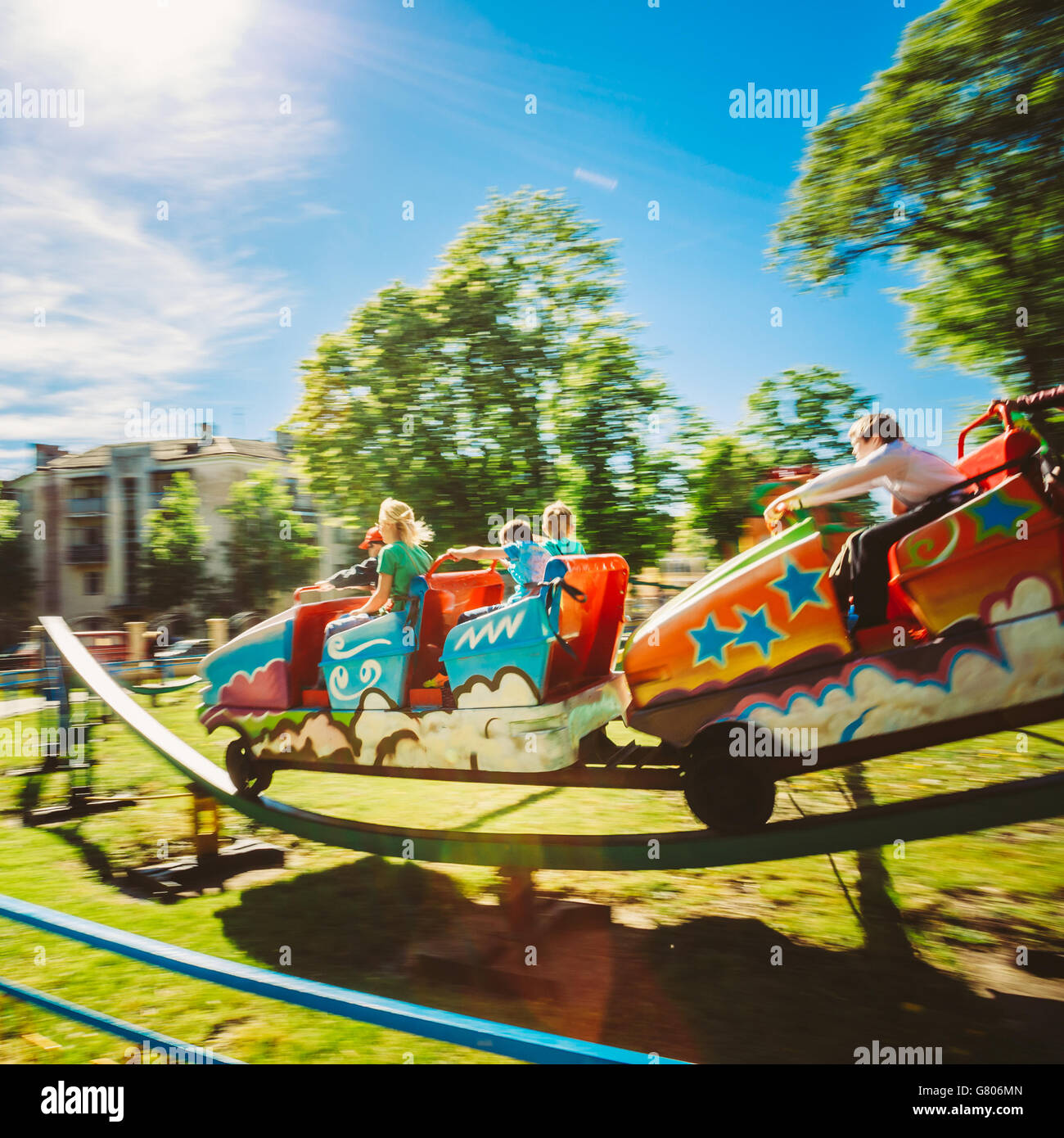 People Having Fun On Rollercoaster In Park. Photo With Zoom Blur For ...