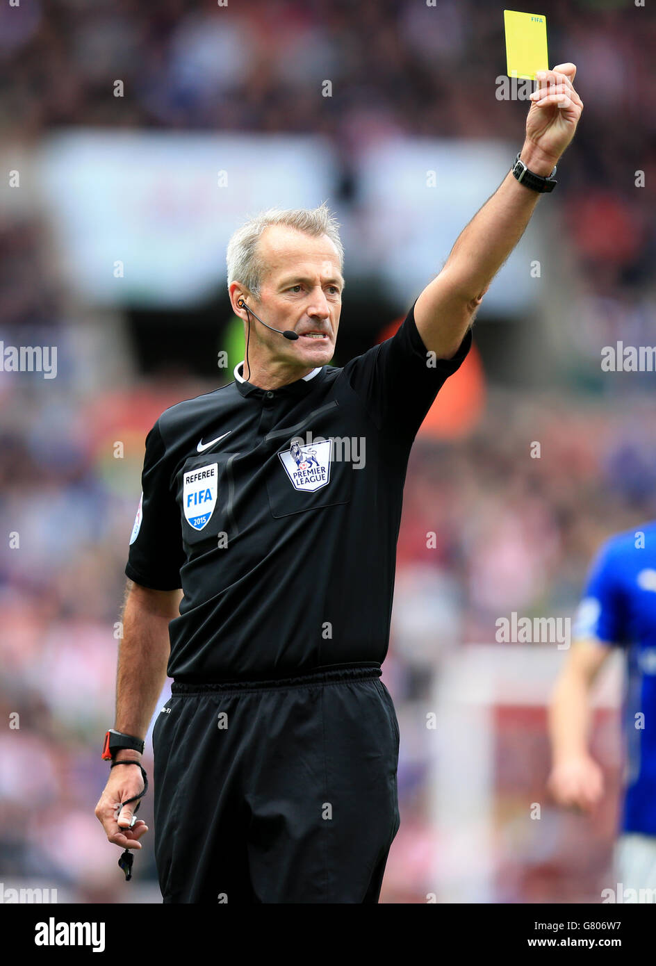 Referee martin atkinson shows a yellow card hi-res stock photography ...