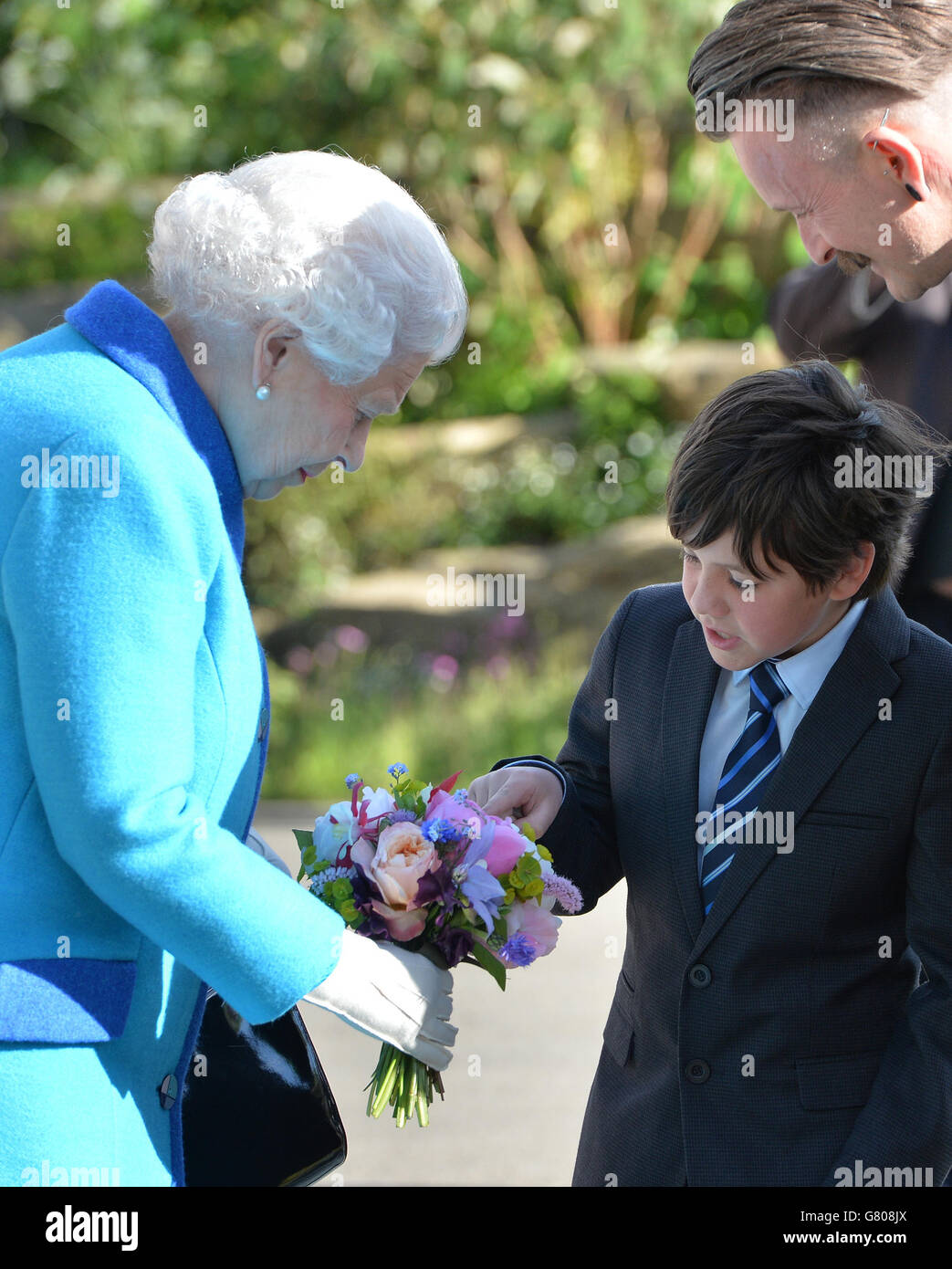 Queen Elizabeth II is presented with a bouquet by 9-year-old George ...