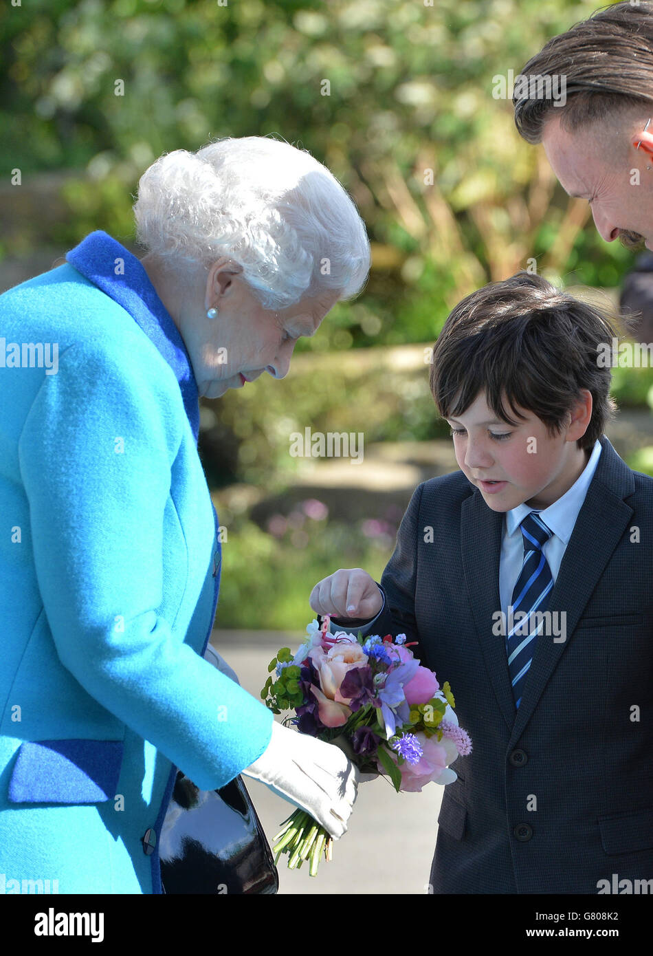 Queen Elizabeth II is presented with a bouquet by 9-year-old George ...