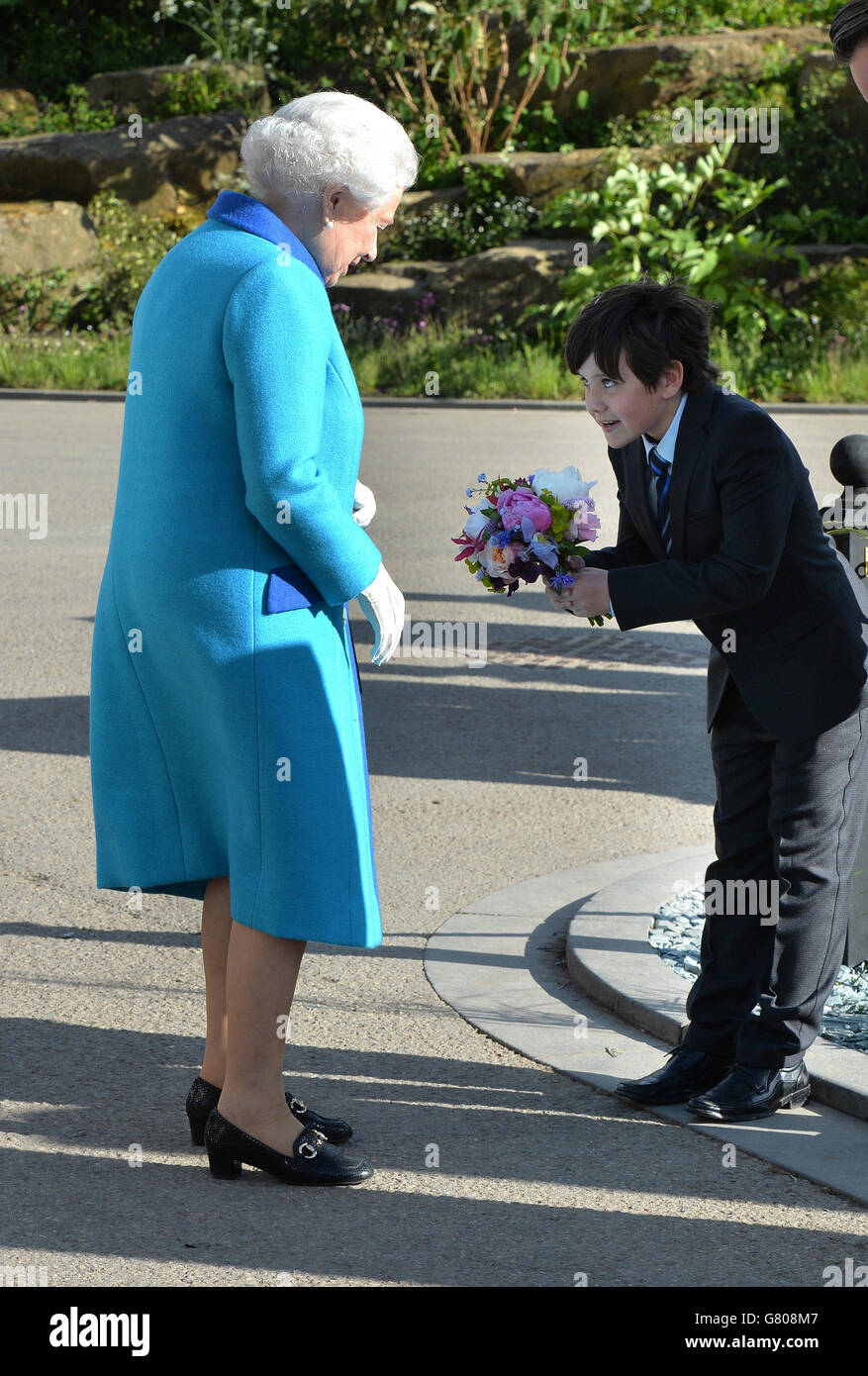 Queen Elizabeth II is presented with a bouquet by 9-year-old George ...