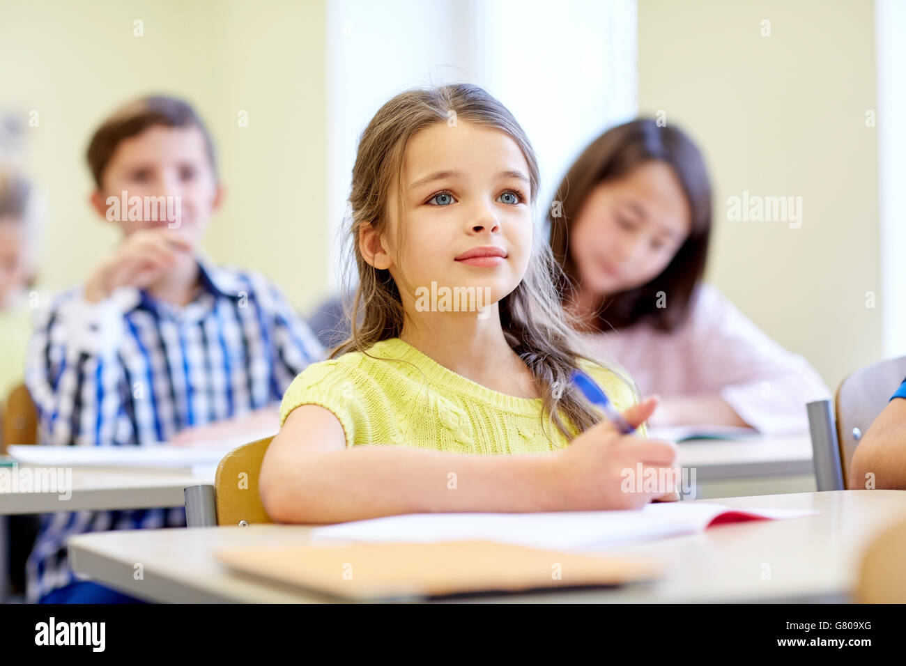 student girl with group of school kids in class Stock Photo - Alamy
