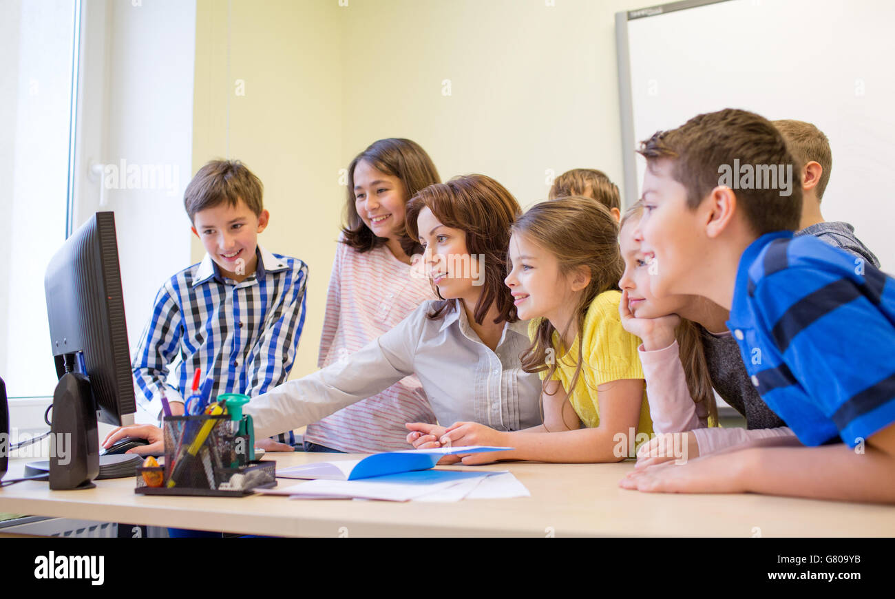 group of kids with teacher and computer at school Stock Photo - Alamy