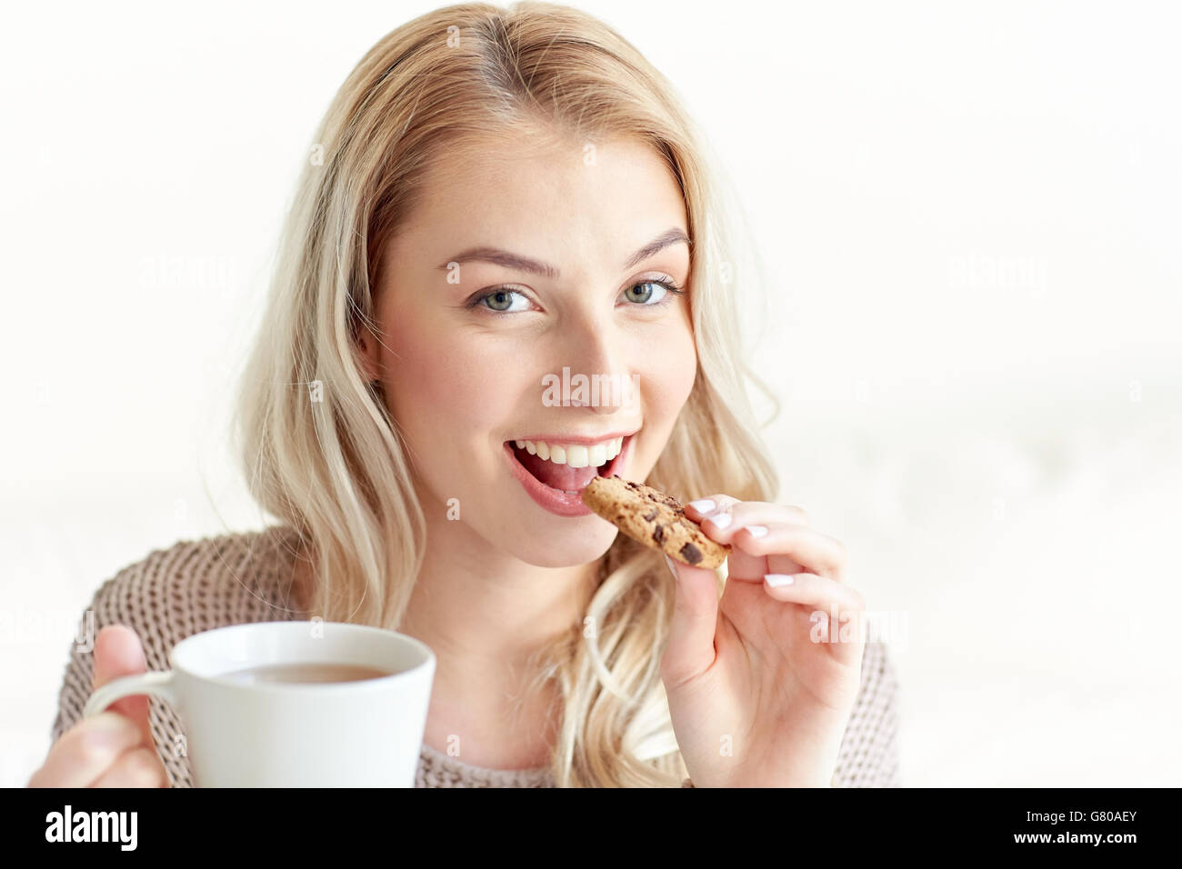 Woman eating biscuit hi-res stock photography and images - Alamy