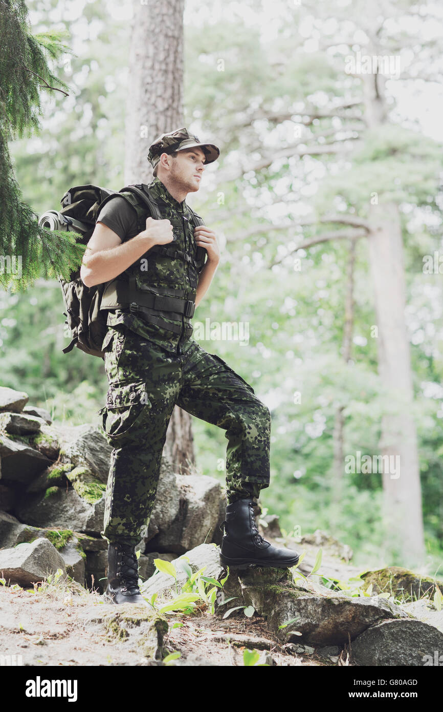 young soldier with backpack in forest Stock Photo - Alamy