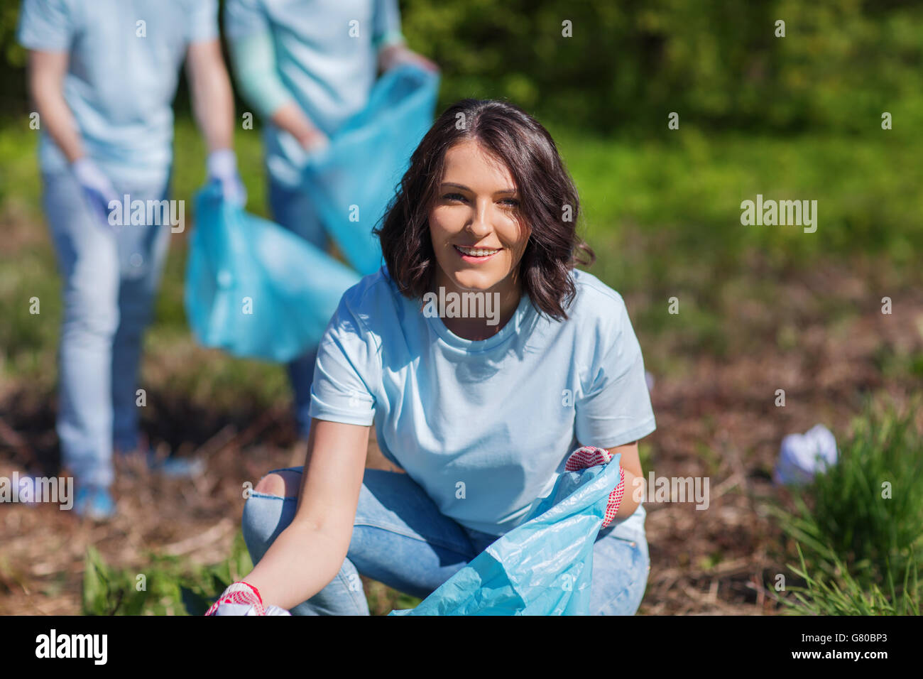 volunteers with garbage bags cleaning park area Stock Photo - Alamy