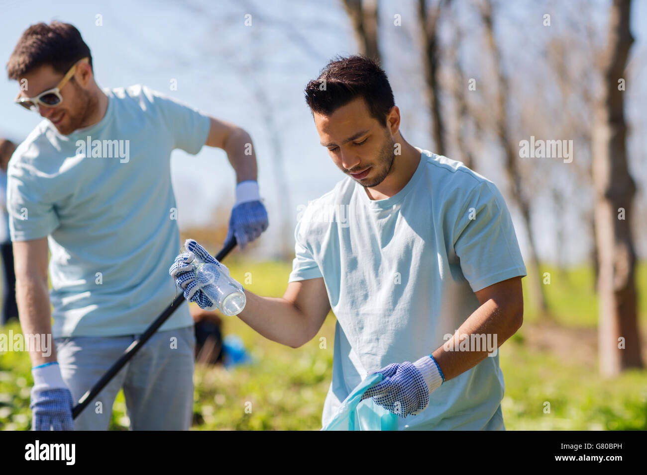 volunteers with garbage bags cleaning park area Stock Photo - Alamy