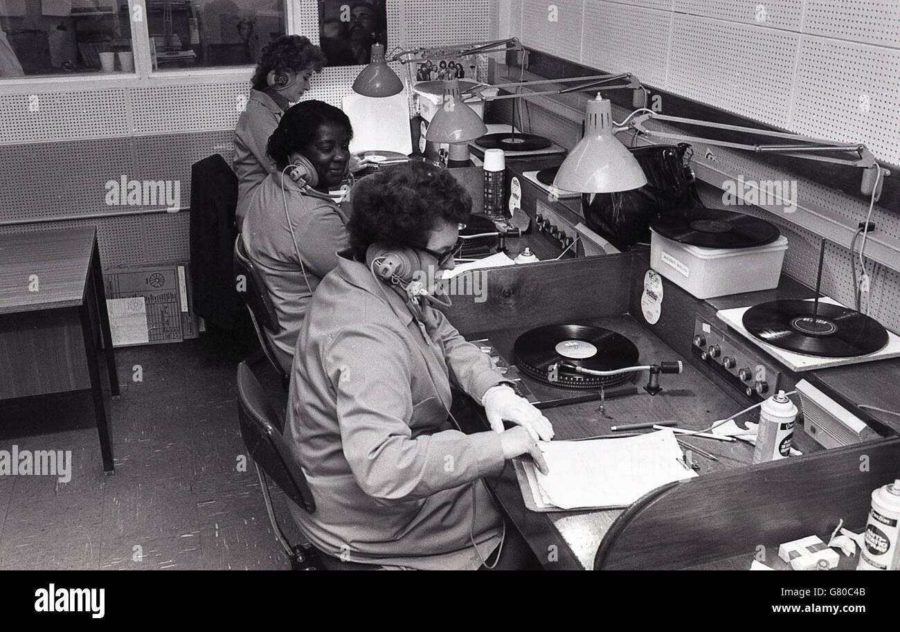 1970s, historical, female workers testing or checking vinyl records or ...