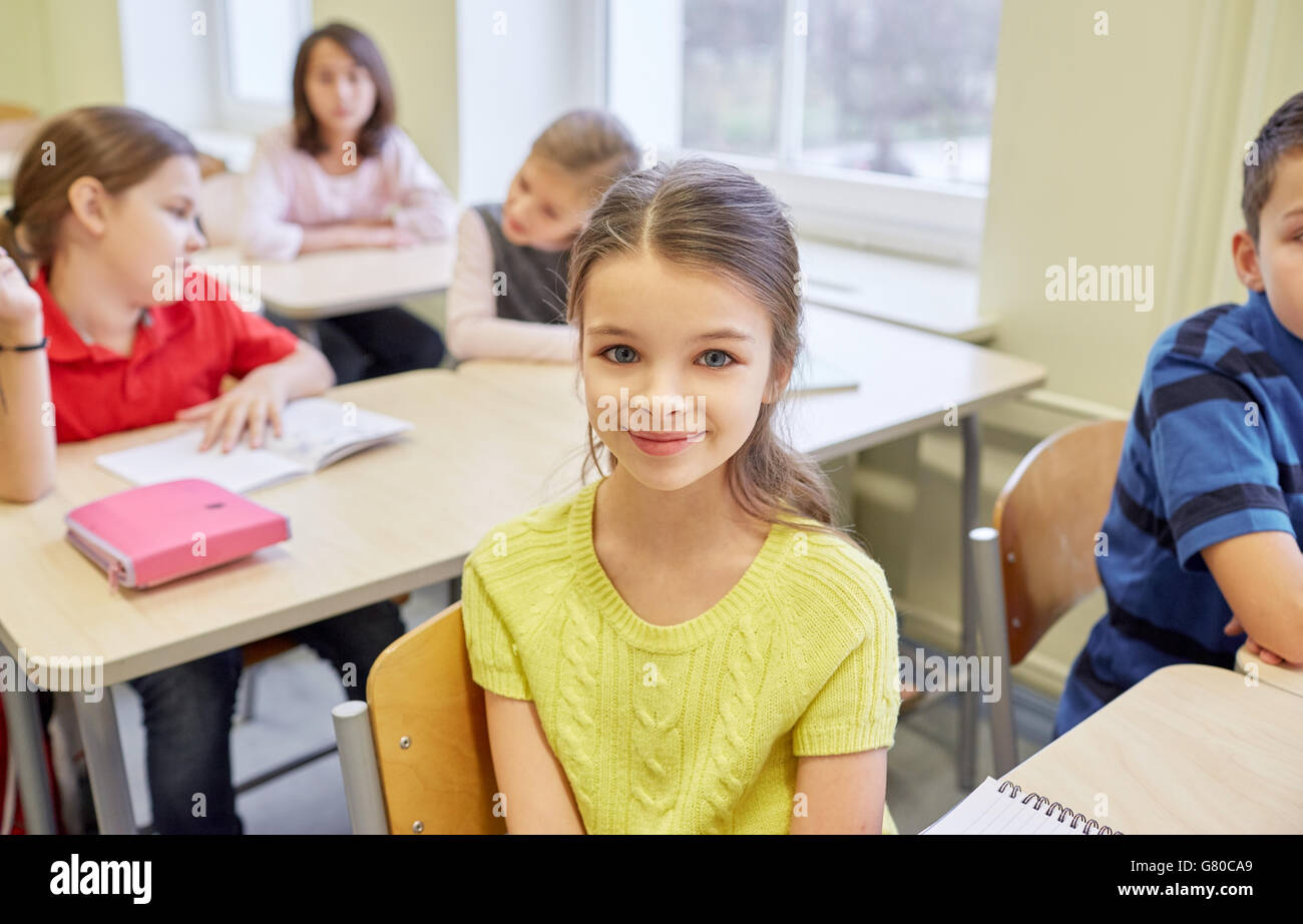 student girl with group of school kids in class Stock Photo - Alamy