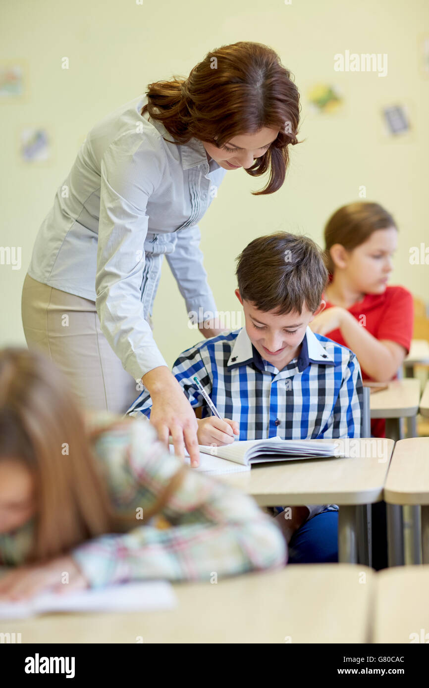 group of school kids writing test in classroom Stock Photo - Alamy