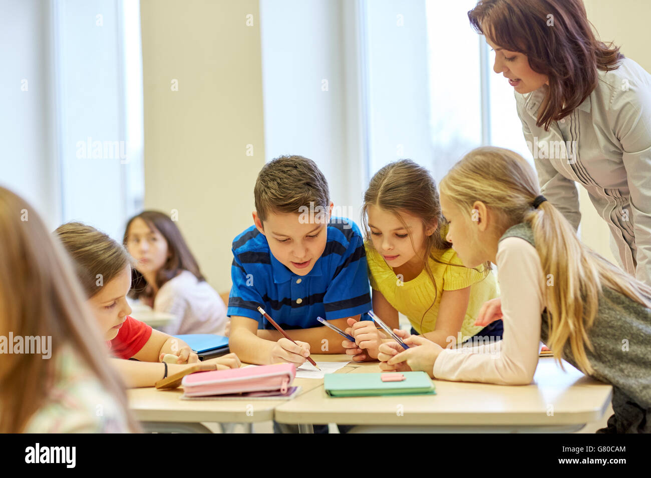 group of school kids writing test in classroom Stock Photo - Alamy