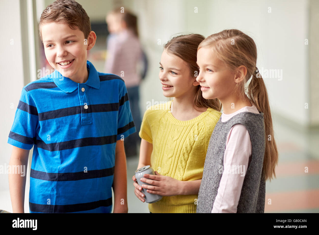 group of smiling school kids talking in corridor Stock Photo - Alamy