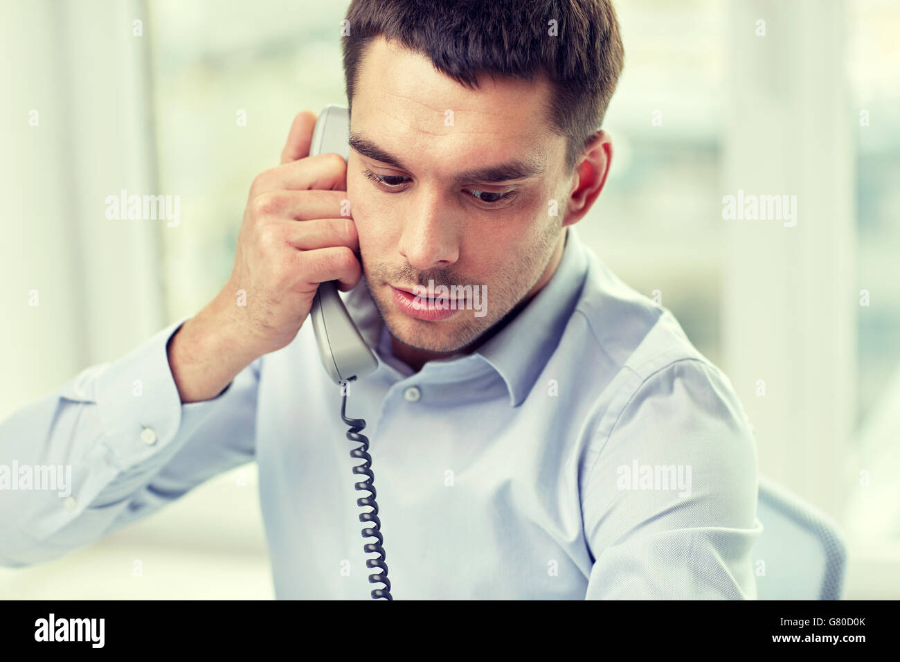 face of businessman calling on phone in office Stock Photo - Alamy