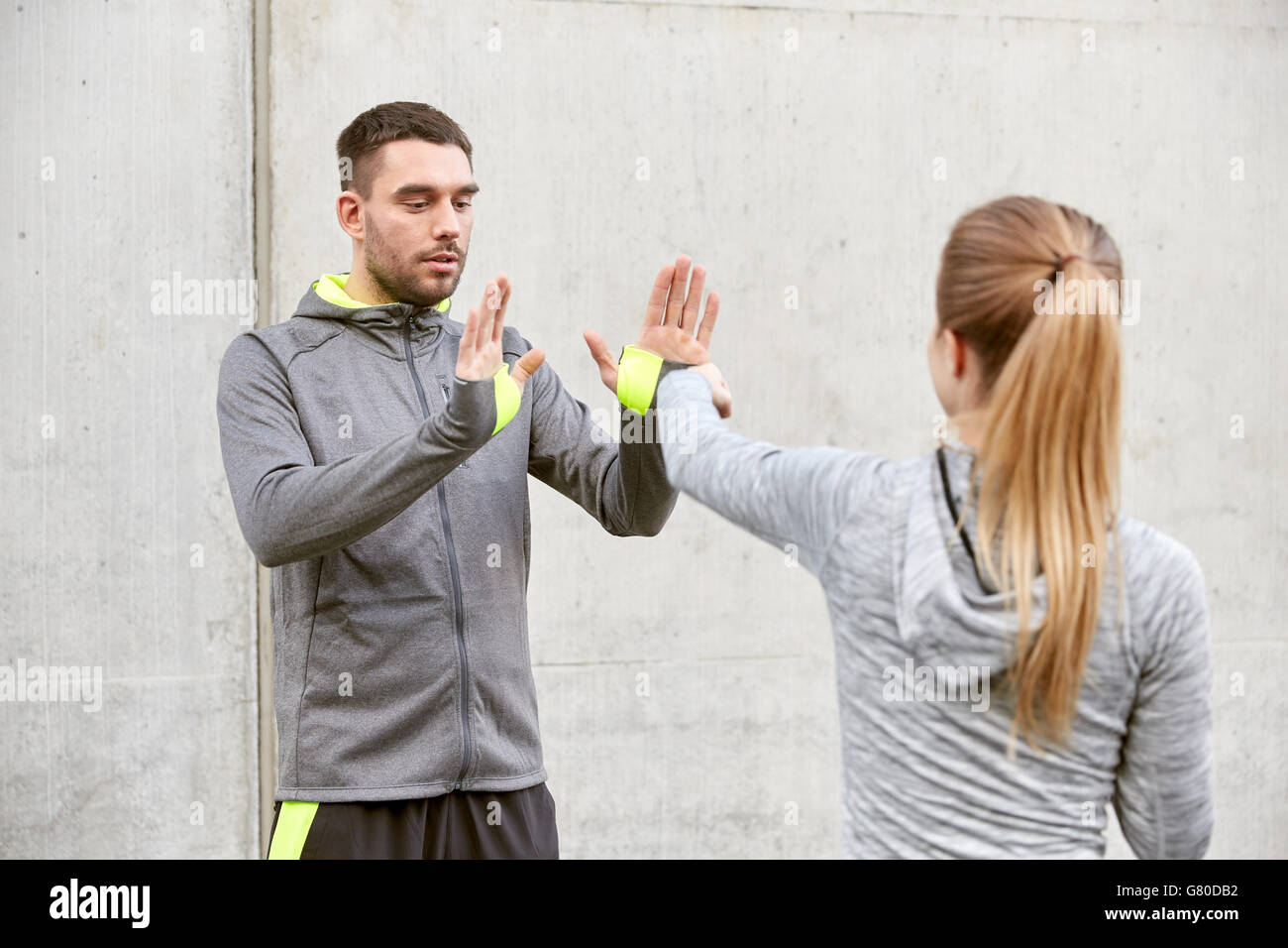 woman with trainer working out self defense strike Stock Photo - Alamy