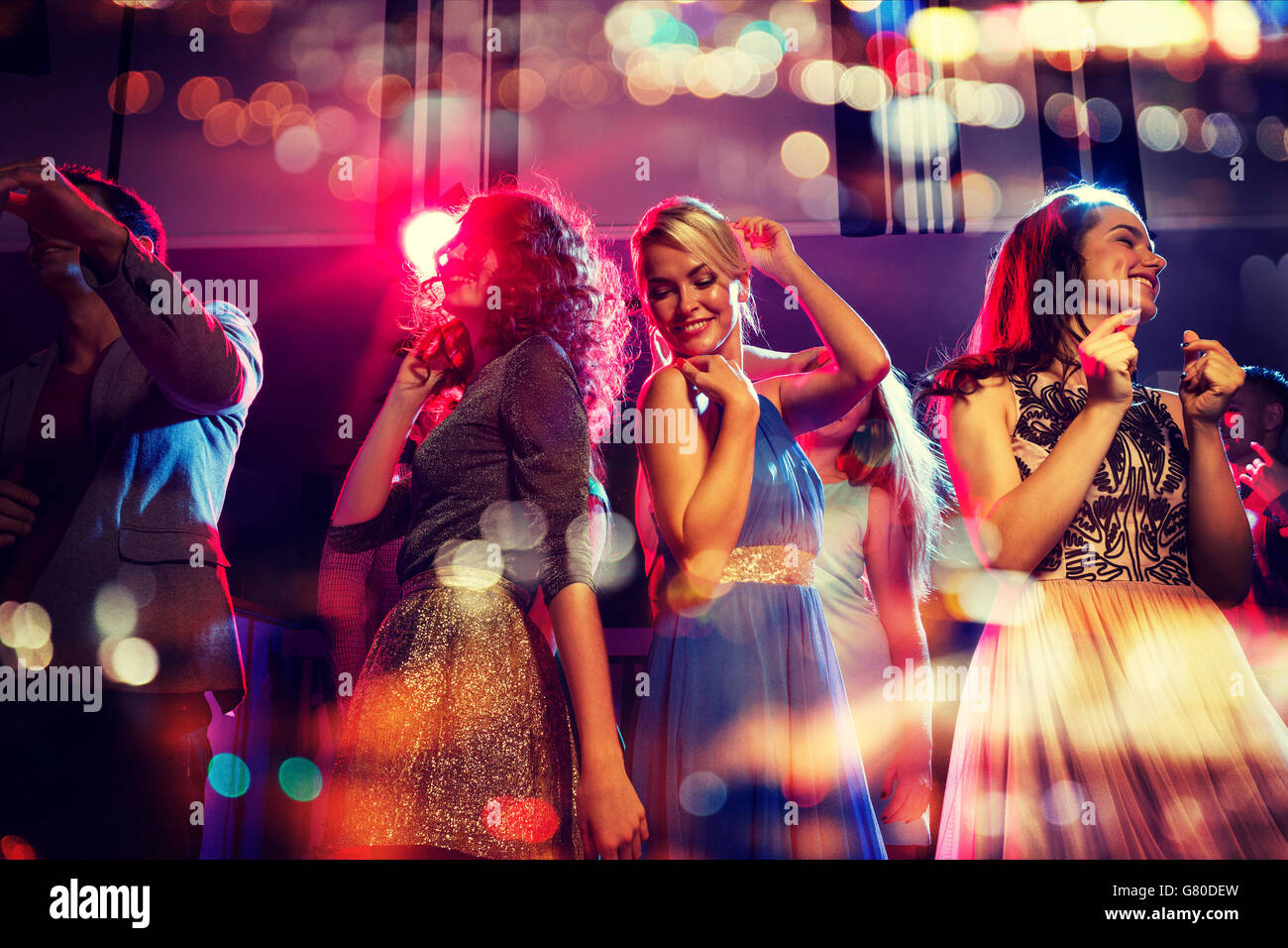 happy friends dancing in club with holidays lights Stock Photo - Alamy