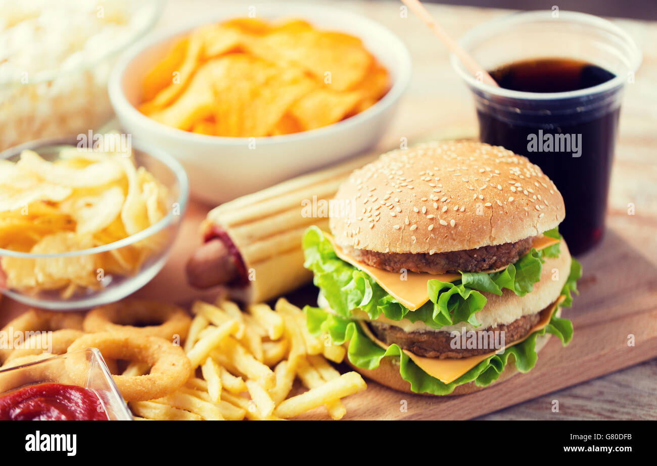 close up of fast food snacks and drink on table Stock Photo - Alamy