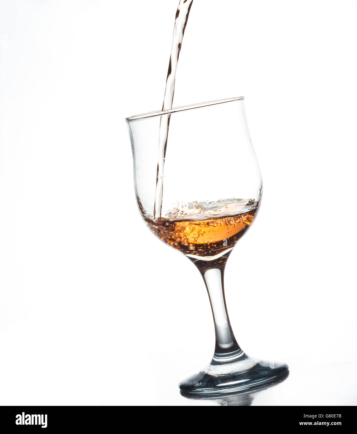 Tilted glass of wine on a white background, sparkling alcoholic ...