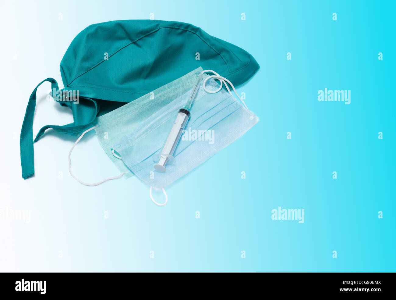 Syringe with doctor's hat and mask isolated on medical background Stock ...