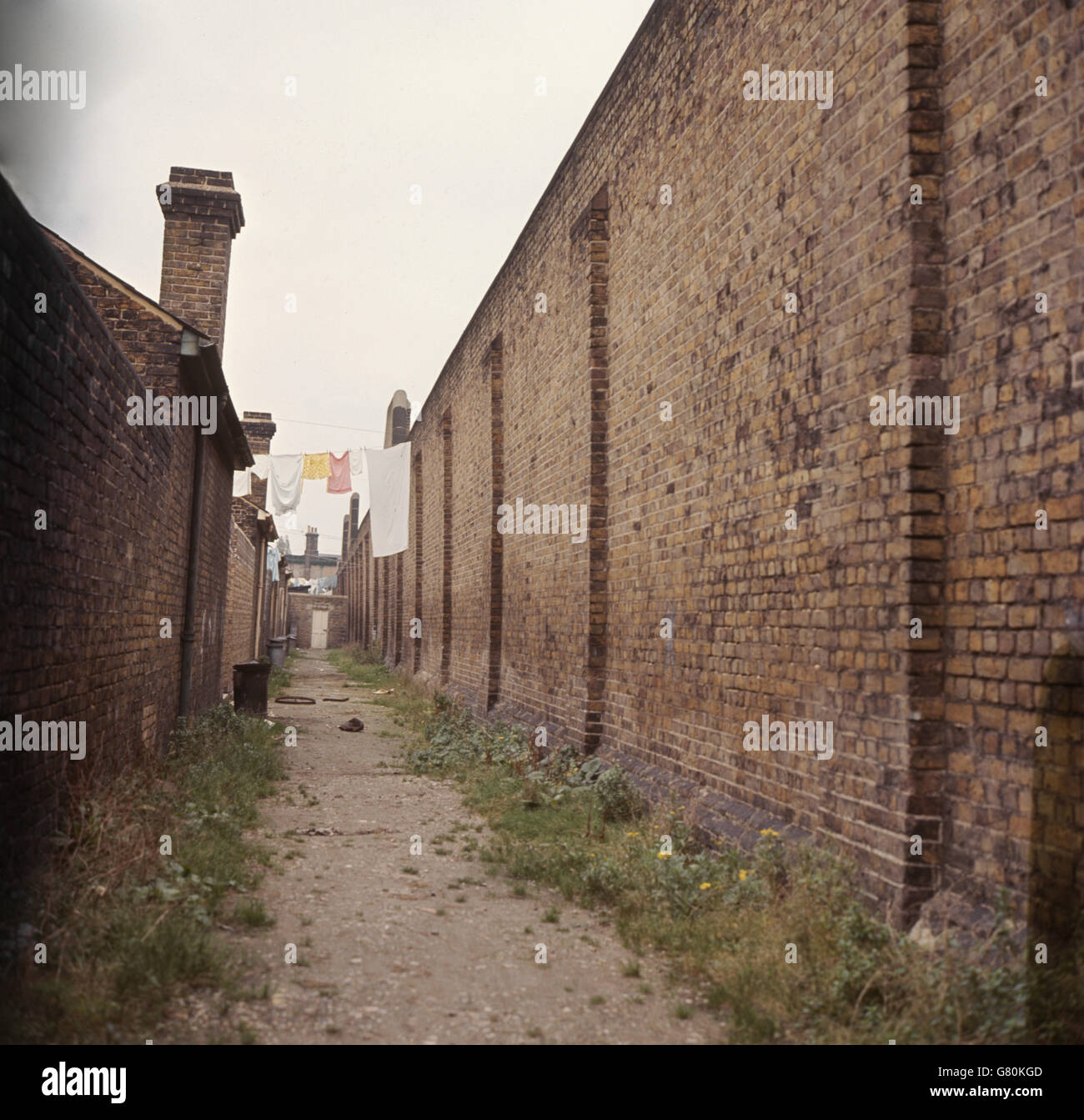 Grim prison wall on one side with prison officers' small houses on ...