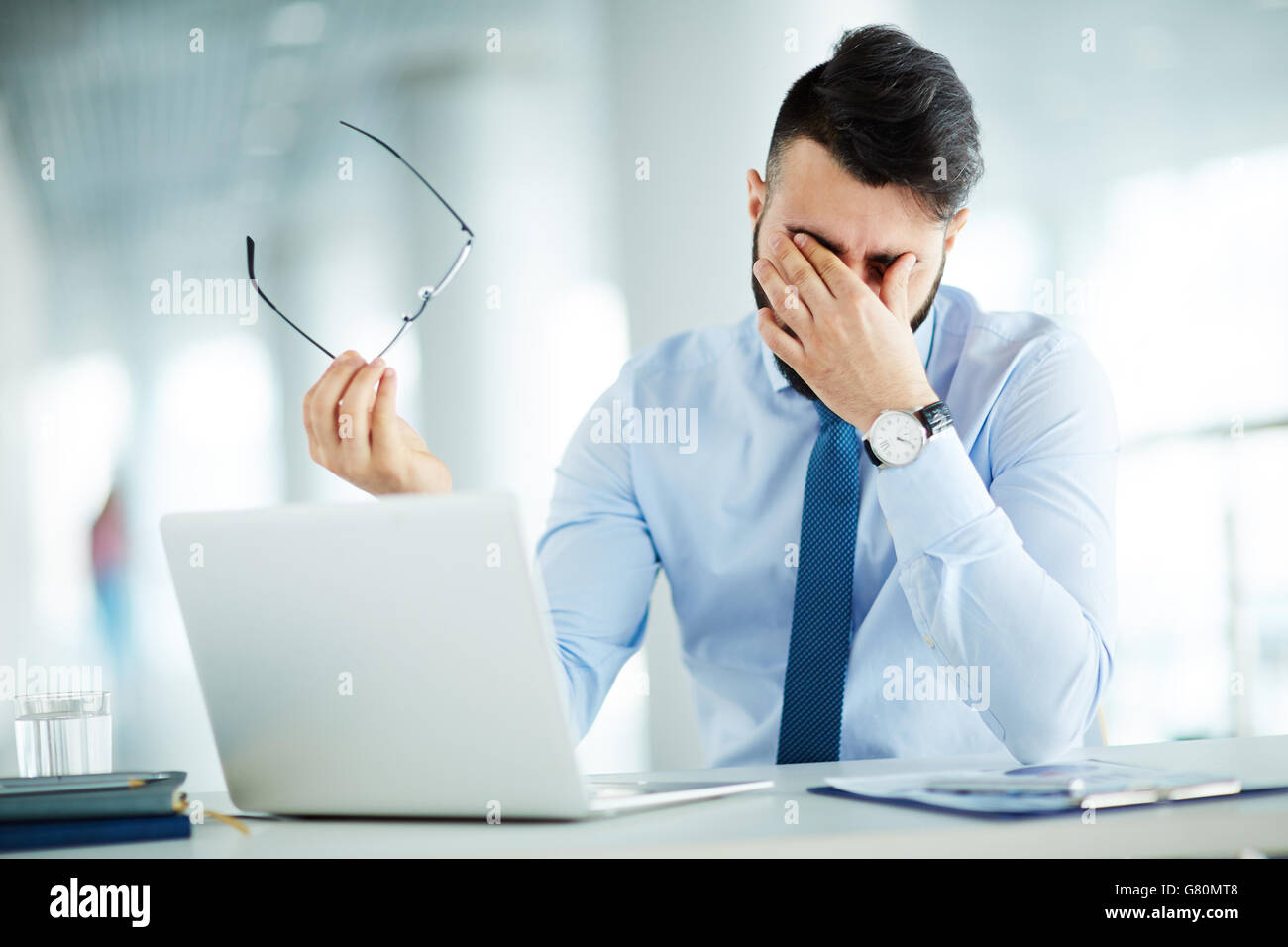 Tired of working with laptop Stock Photo - Alamy