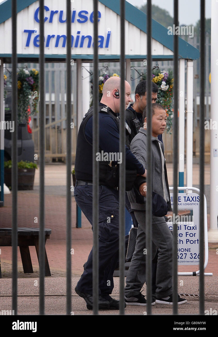 A man is led away by Border Force staff at Harwich International port ...