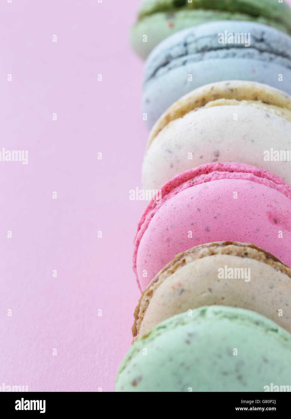 French multicolored almond cookies macaroons on a pink background Stock ...
