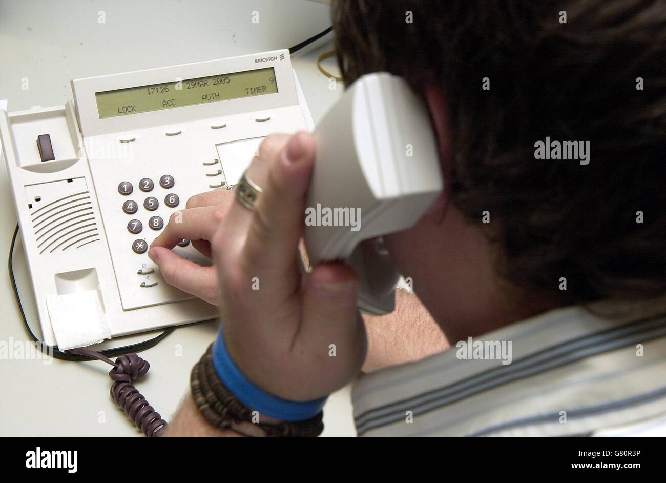 An office worker in London using the telephone as part of their work ...