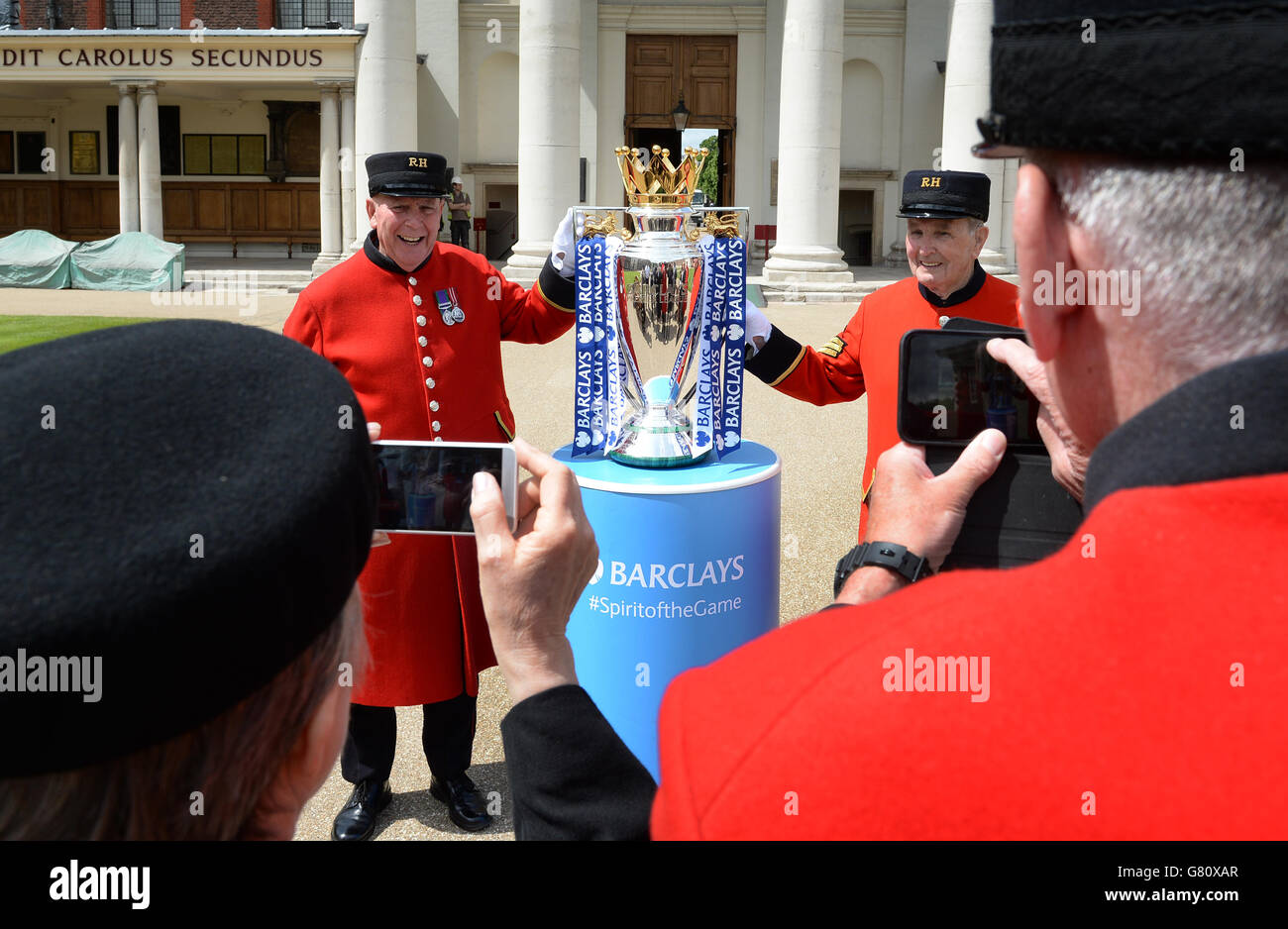 Chelsea Pensioners photograph themselves with the Premier League trophy ...
