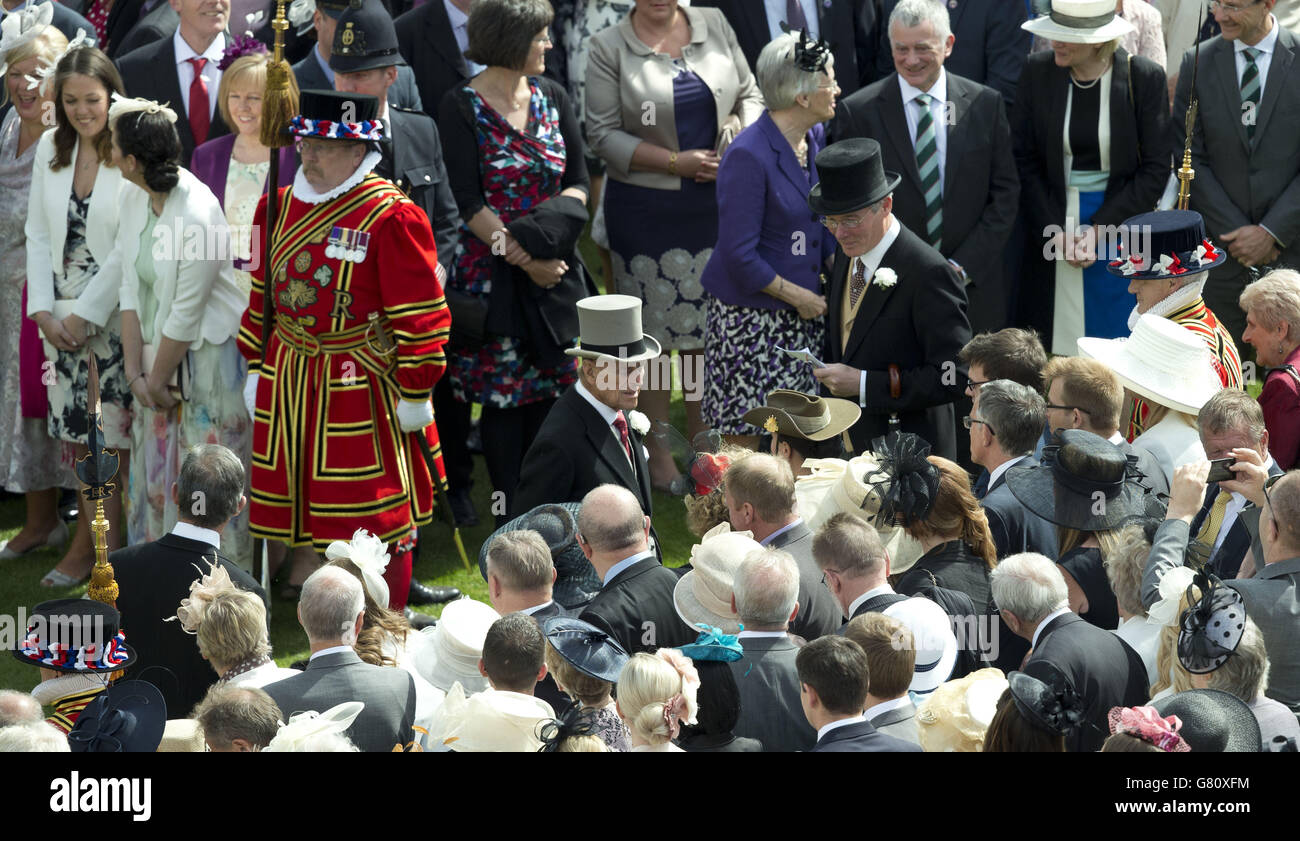 The Duke of Edinburgh talks to guests during a garden party held at ...