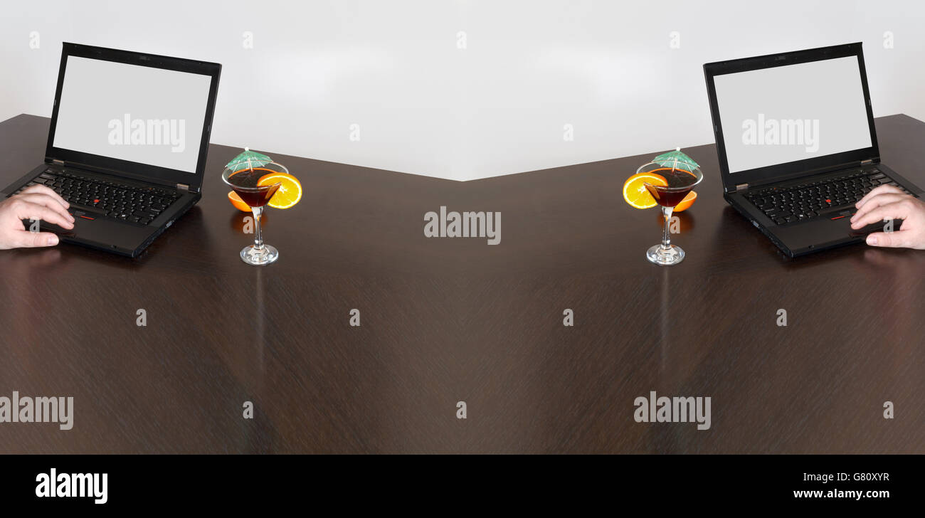 Laptop with white screen for copy on a table next to a glass of ...