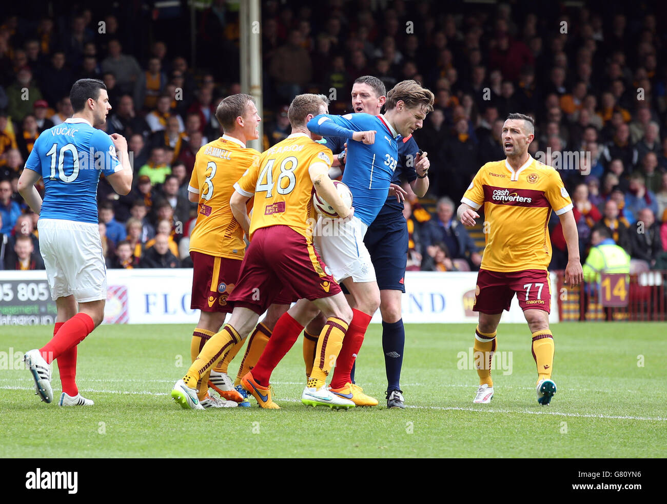 Motherwell's Stephen Pearson clashes with Rangers' Marius Zaliukas ...