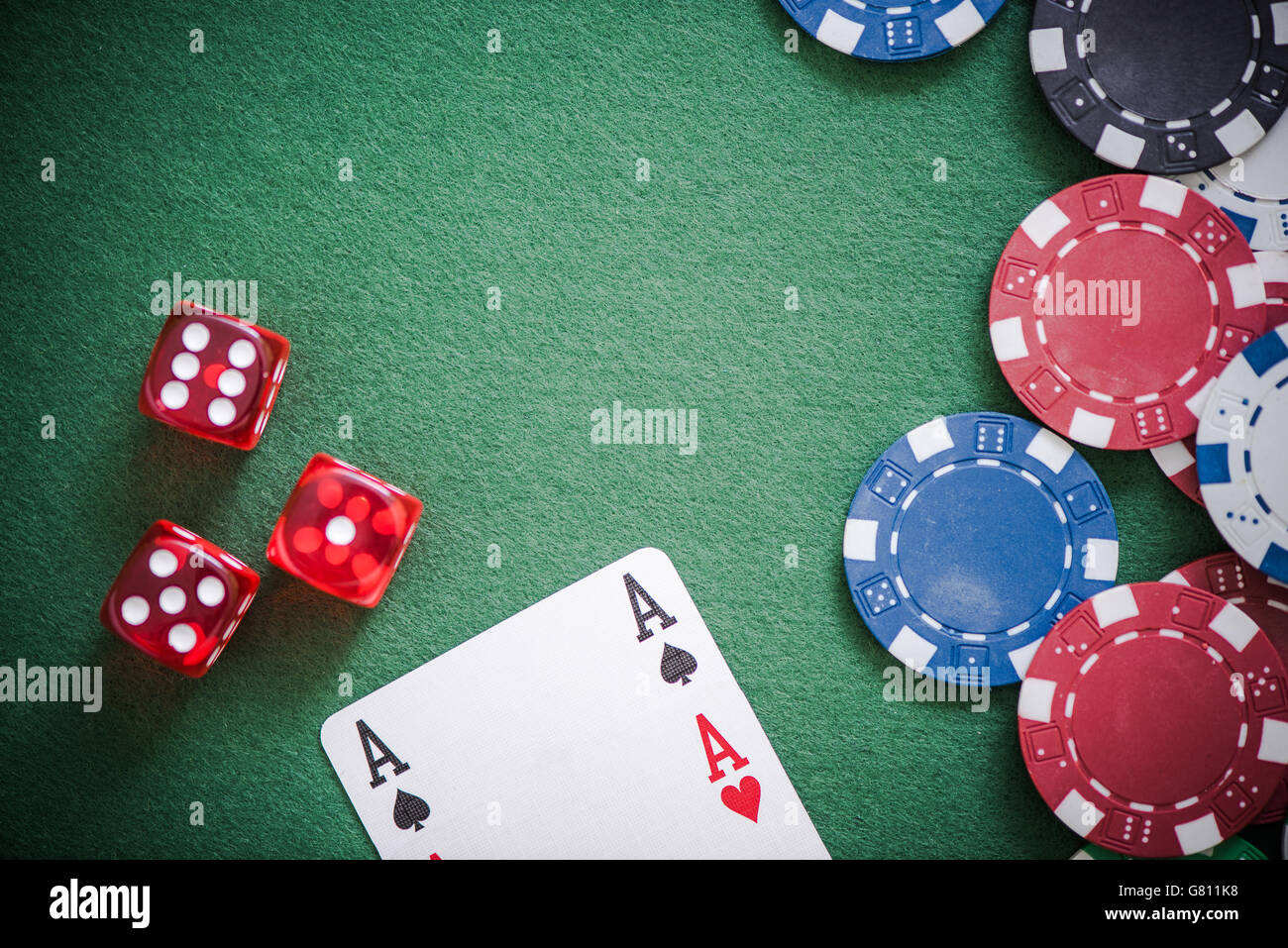 playing cards,dices and poker chips from above on green poker table ...