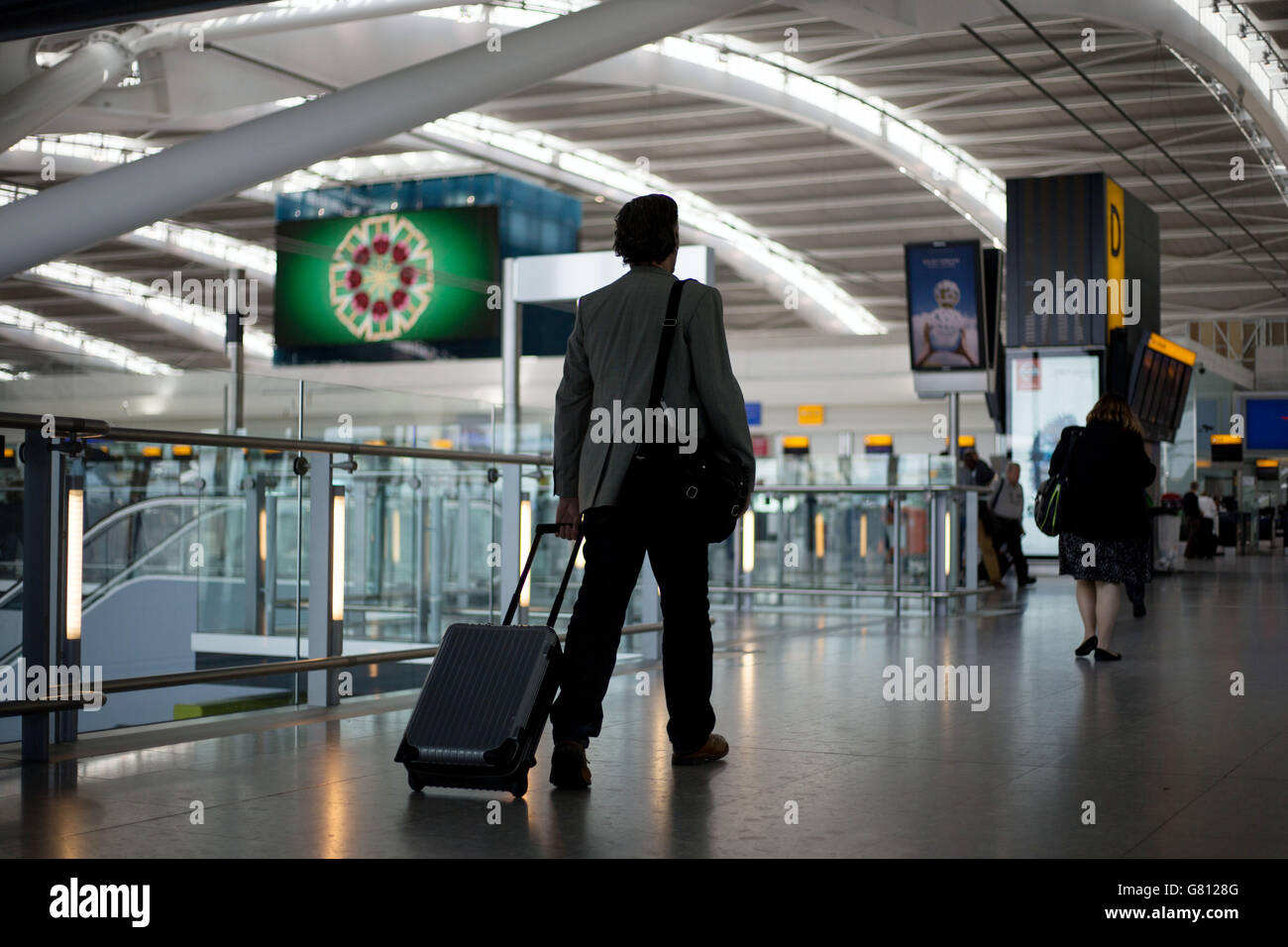 Passengers arrive at terminal 5 of heathrow airport hi-res stock ...